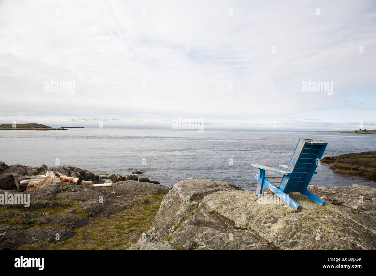A lawn chair sits atop a rock outcrop overlooking the ocean on an ...