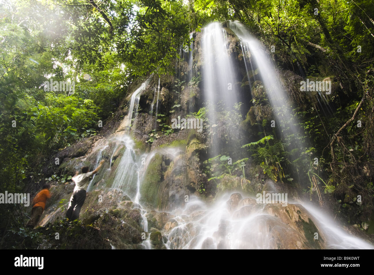 Young men stand below a waterfall near the Lacandon Maya community of ...