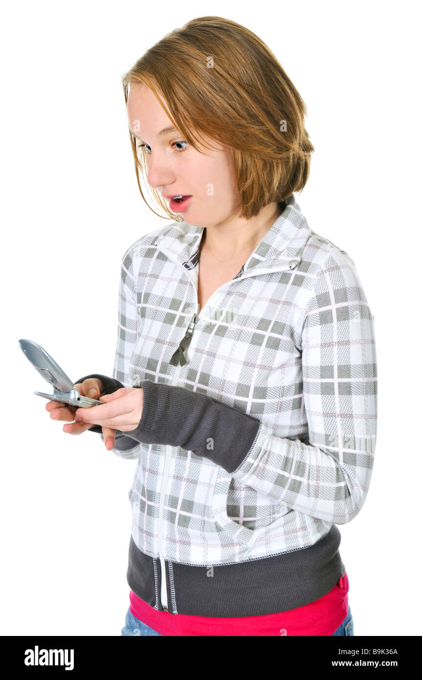 Teenage girl text messaging on a cell phone isolated on white ...