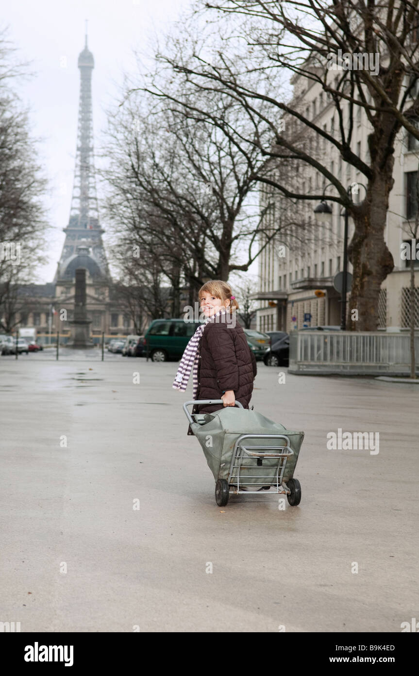 Girl running with shopping cart Stock Photo - Alamy