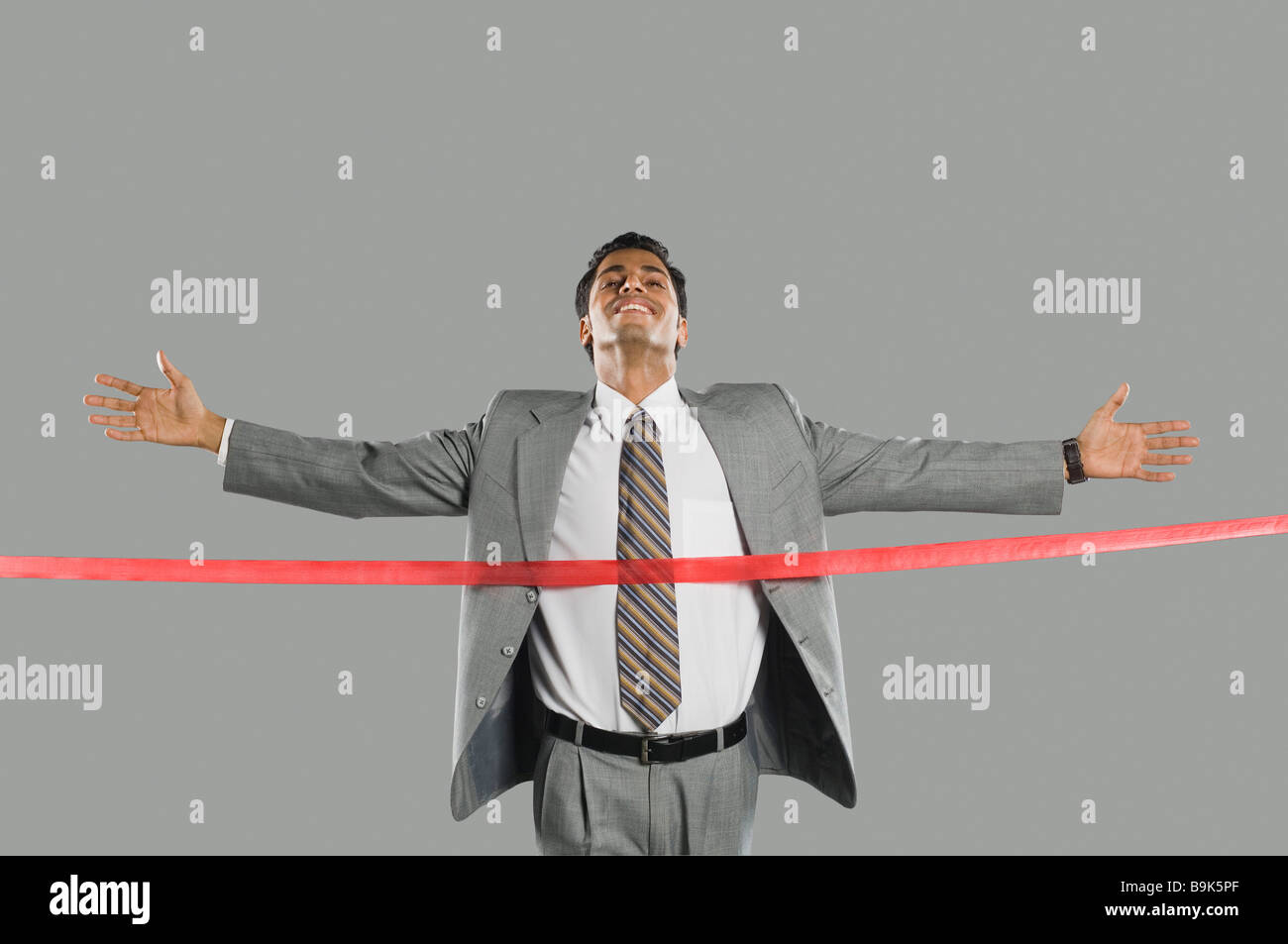 Businessman crossing the finishing line Stock Photo - Alamy