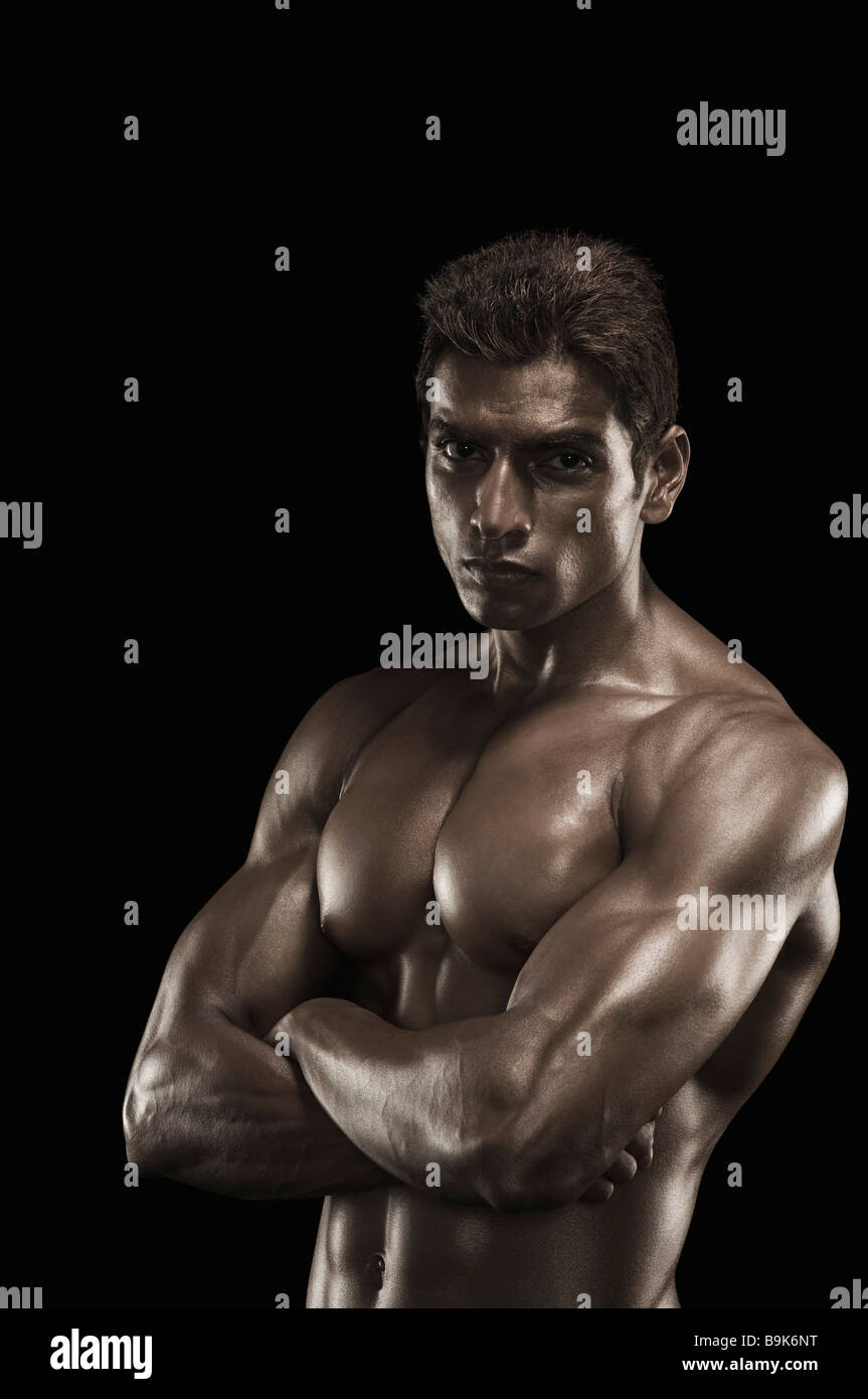 Portrait of a man flexing muscles Stock Photo - Alamy