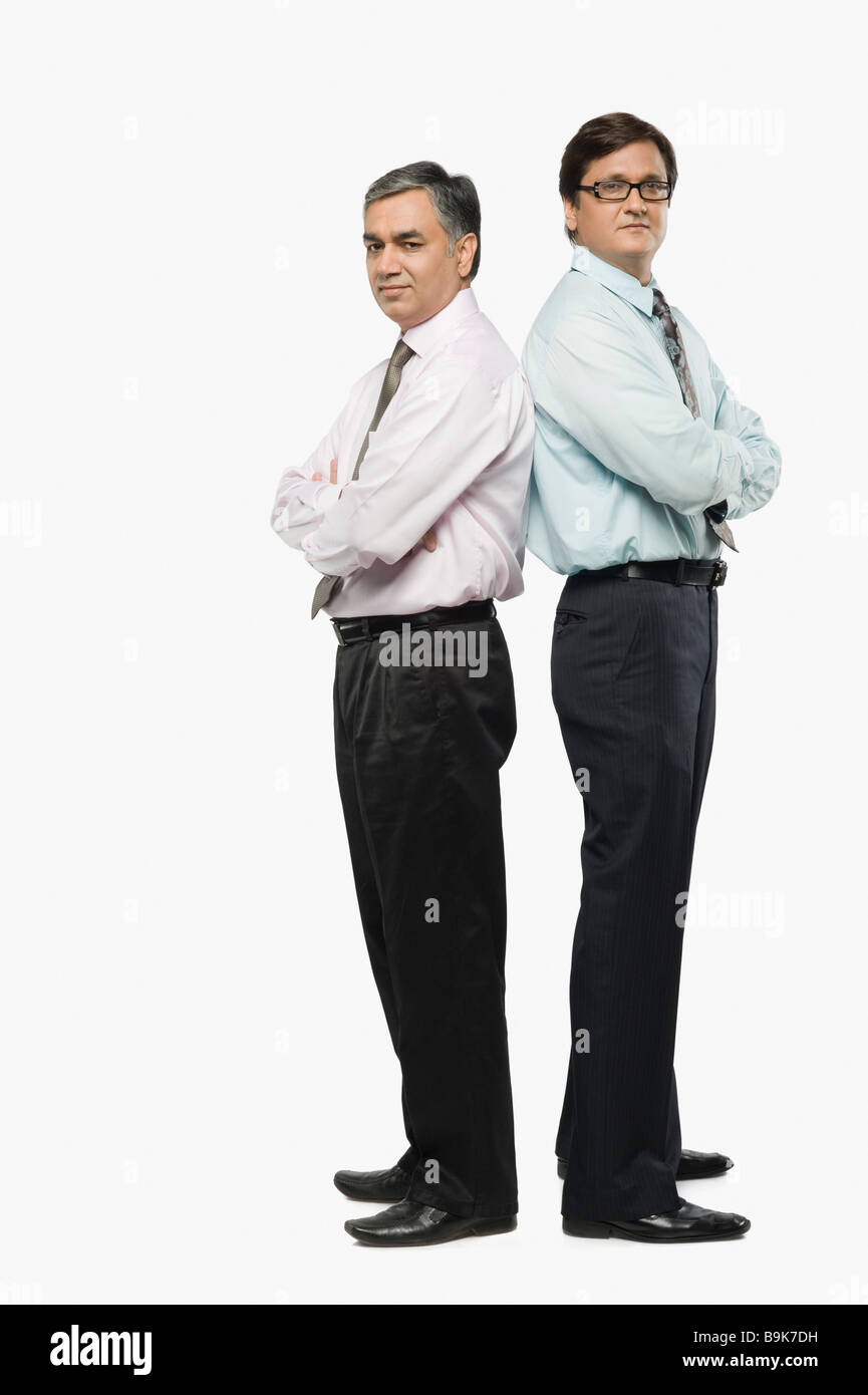 Two businessmen standing back to back Stock Photo - Alamy