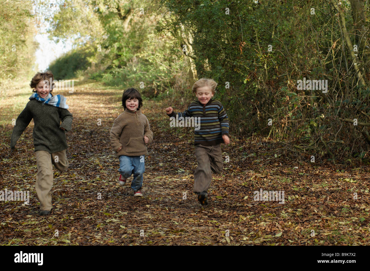 Boys running down country lane Stock Photo - Alamy