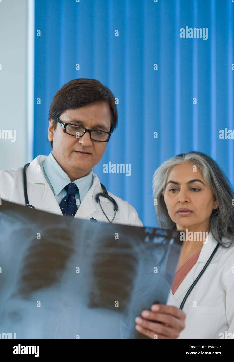 Two doctors examining an x-ray report Stock Photo - Alamy