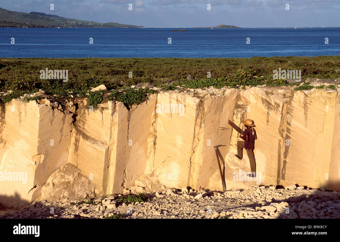 Mauritius, Rodrigues Island, Petite Butte, Jacquelin cutting coral ...