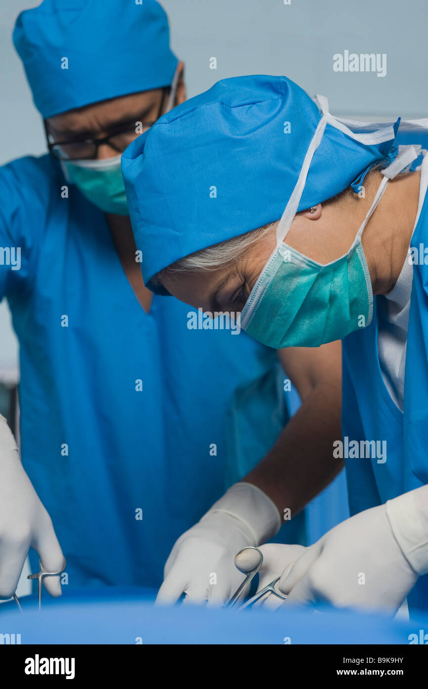 Two surgeons performing a surgery in an operating room Stock Photo - Alamy