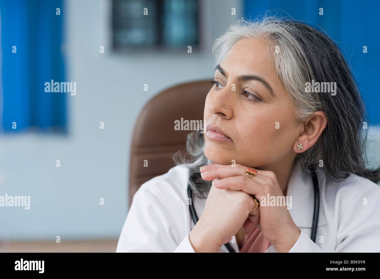 Close-up of a female doctor thinking Stock Photo - Alamy