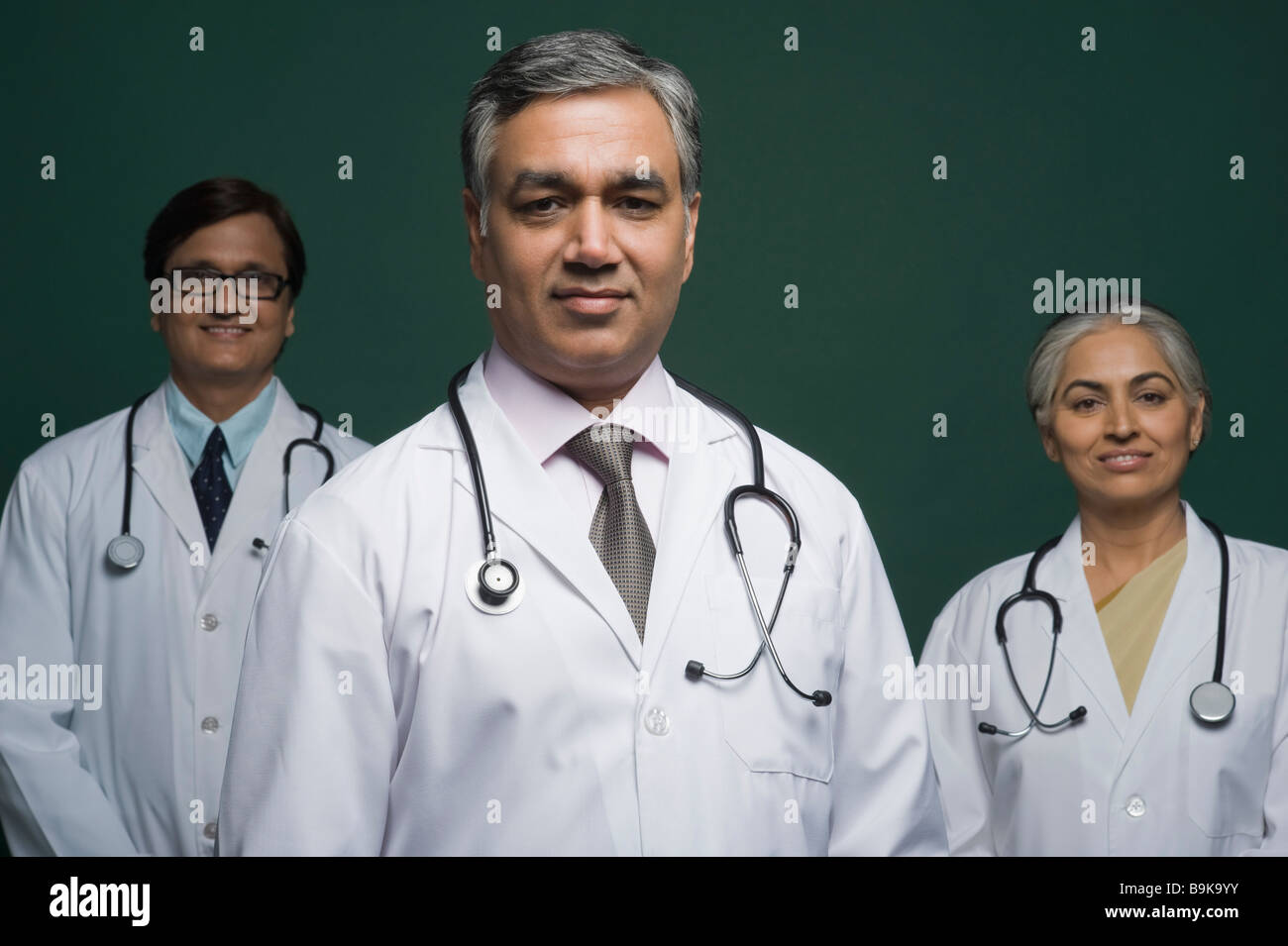 Portrait of three doctors smiling Stock Photo - Alamy
