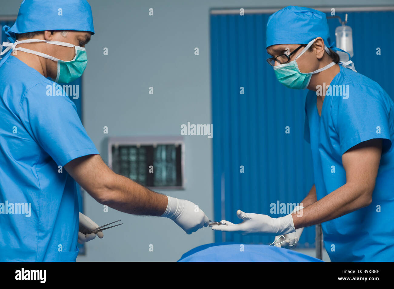 Two surgeons performing a surgery in an operating room Stock Photo - Alamy