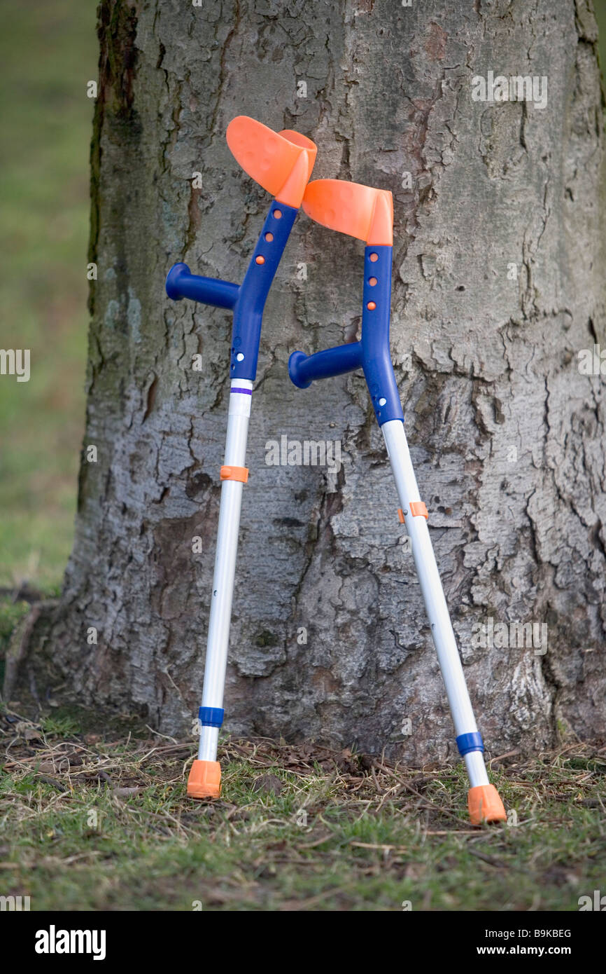 Child s crutches against a tree Stock Photo - Alamy