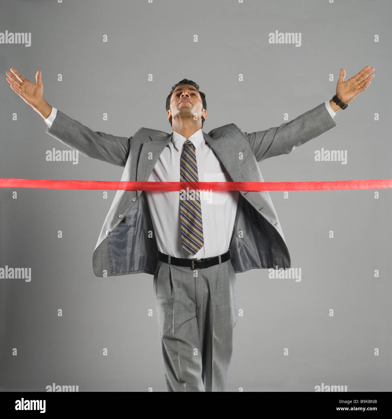 Businessman crossing the finishing line Stock Photo - Alamy