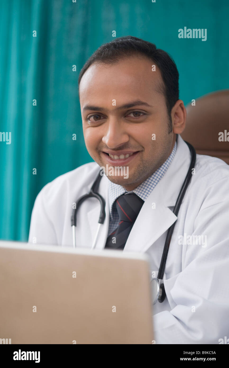 Indian male doctor looking laptop hi-res stock photography and images ...