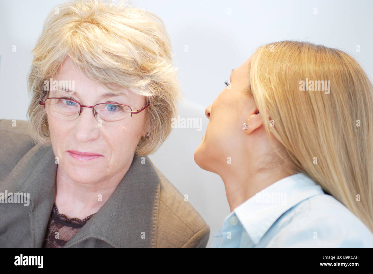 two women executives sharing a secret Stock Photo - Alamy