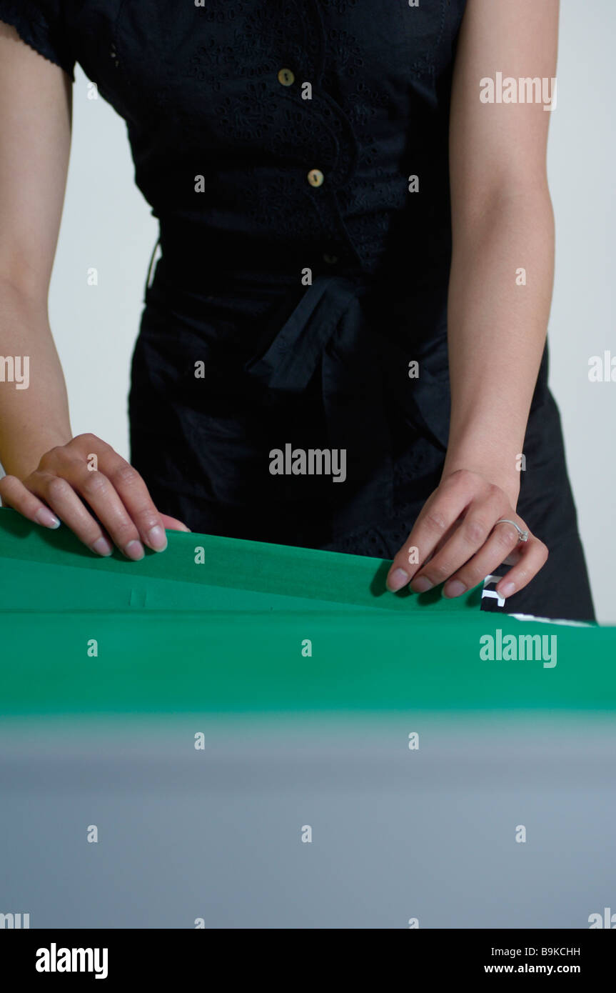 close-up of woman going through files in filing cabinet Stock Photo - Alamy