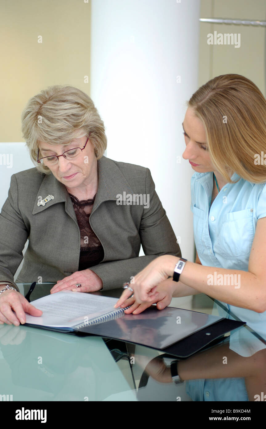 two female executives discussing file Stock Photo - Alamy