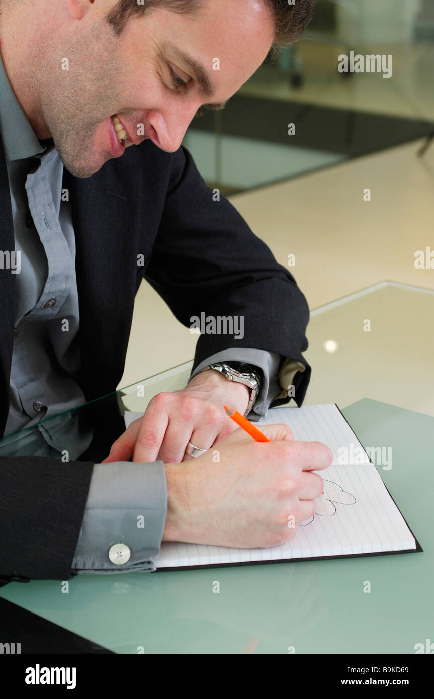 bored businessman drawing a doodle Stock Photo - Alamy