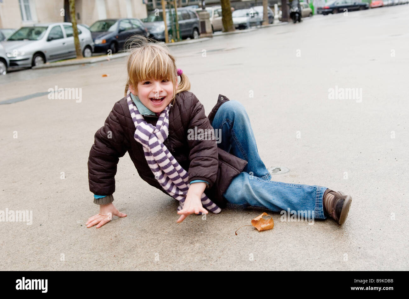 Girl getting up from fall Stock Photo - Alamy