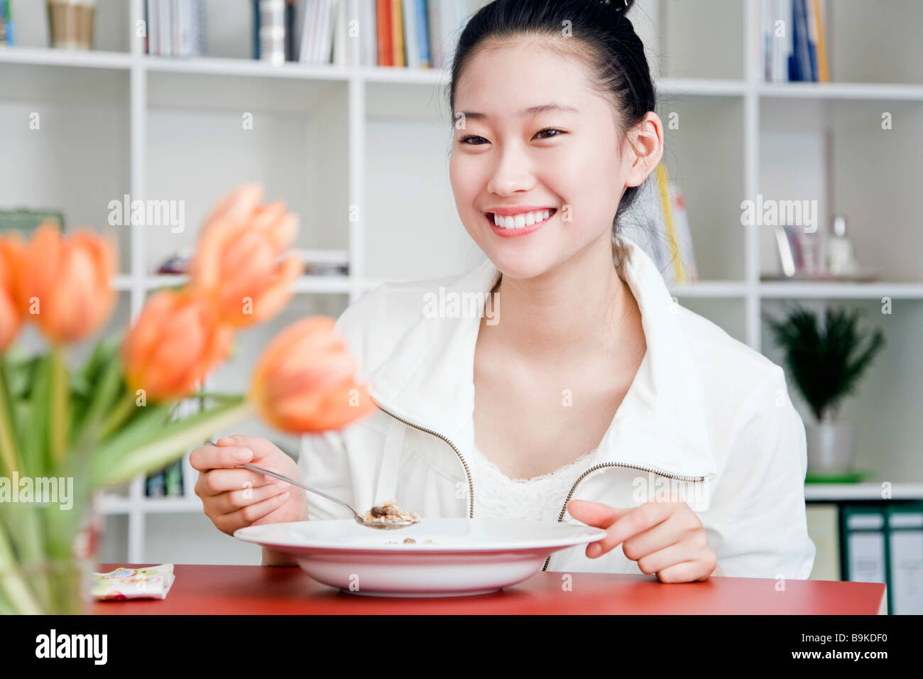 portrait of young japanese girl eating at table Stock Photo - Alamy