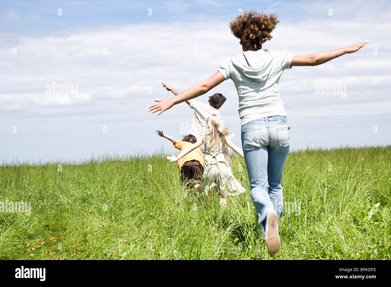 family playing in meadow Stock Photo - Alamy