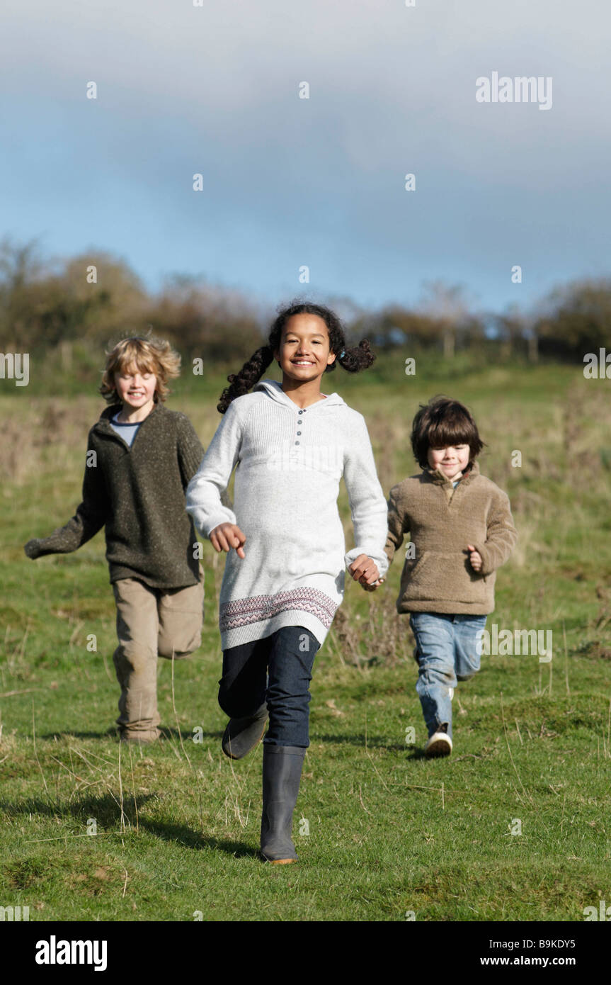 Children running in field Stock Photo - Alamy