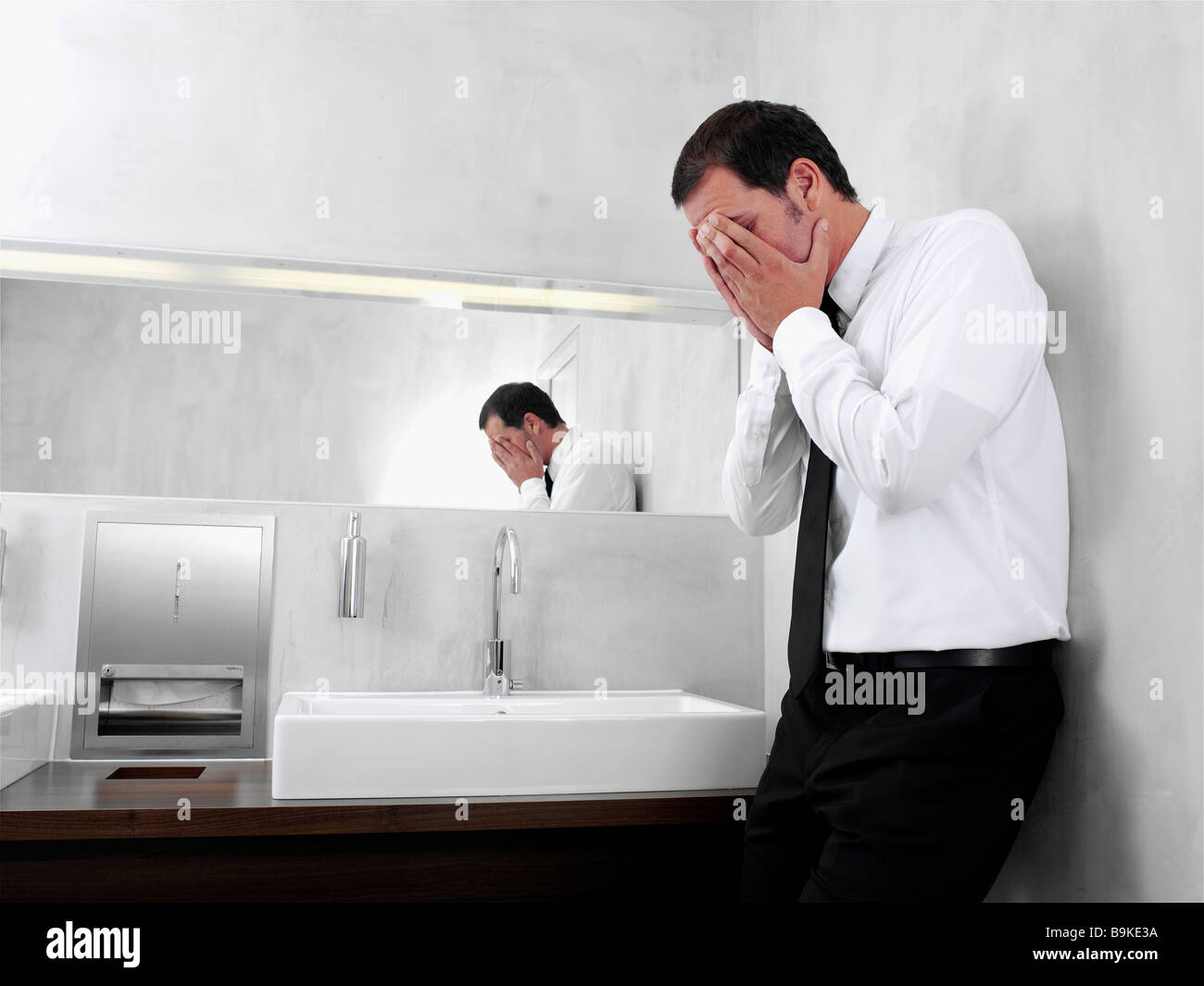 portrait of desperate businessman in public restroom Stock Photo - Alamy