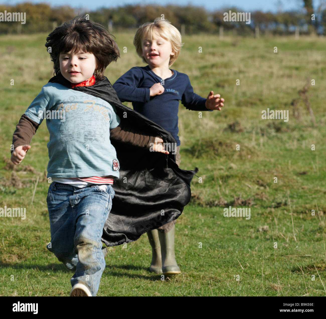 Super Hero boy and friend in field Stock Photo - Alamy