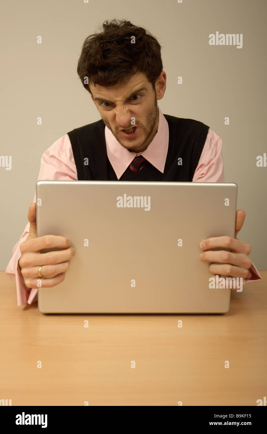 angry businessman having problem with his laptop computer Stock Photo ...
