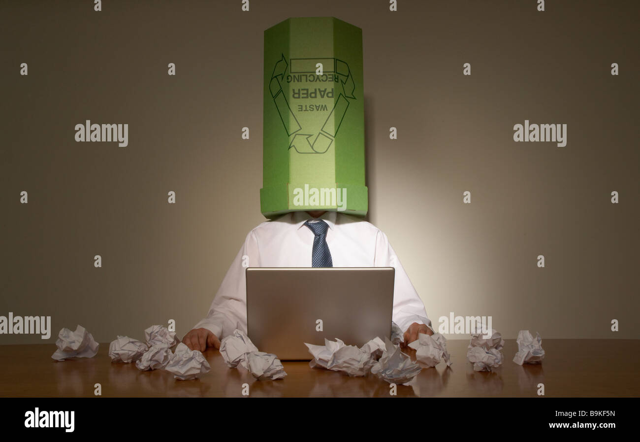 businessman sitting at untidy desk with wastebasket over his head Stock ...