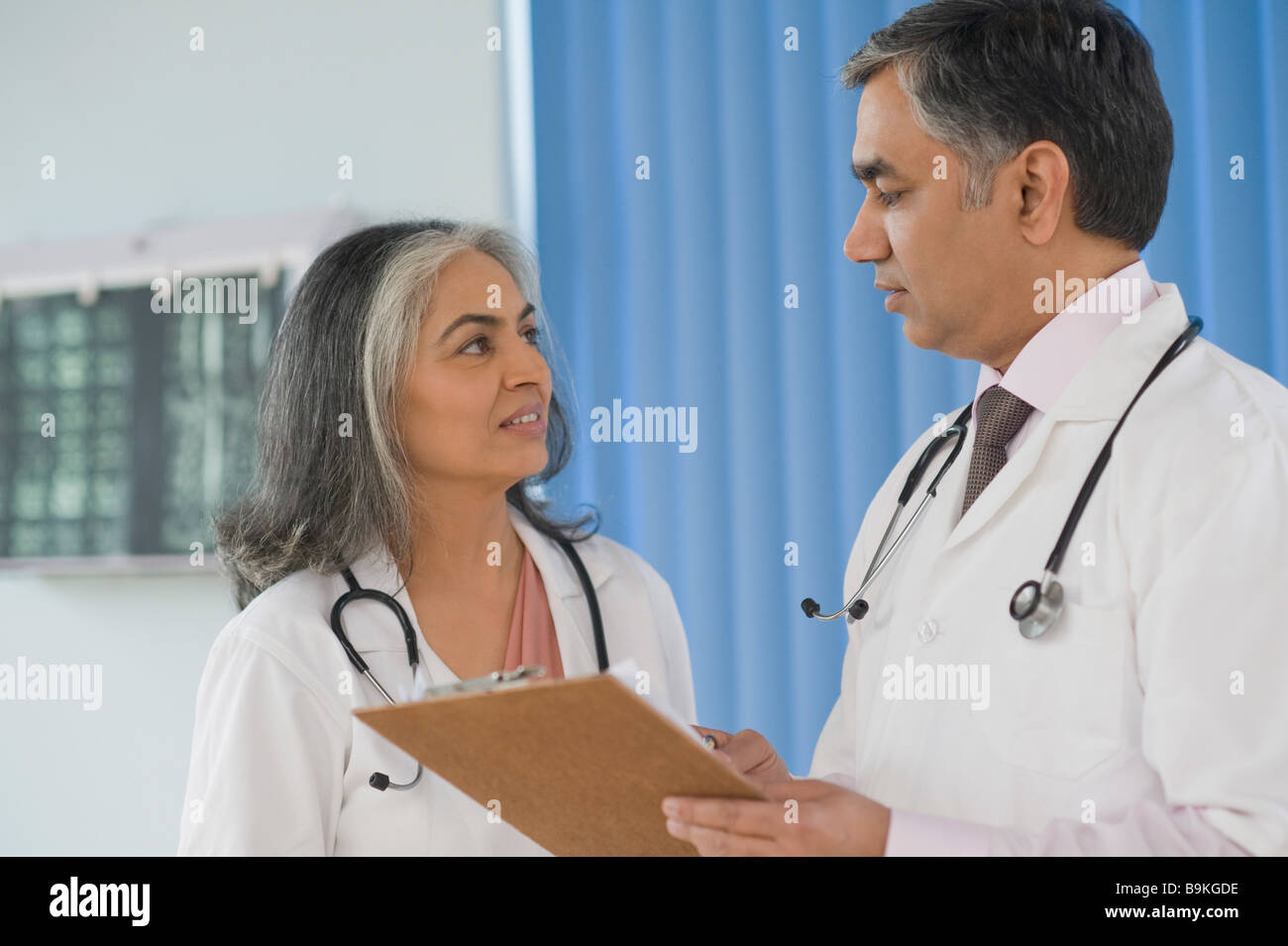Female doctor discussing with a doctor Stock Photo - Alamy