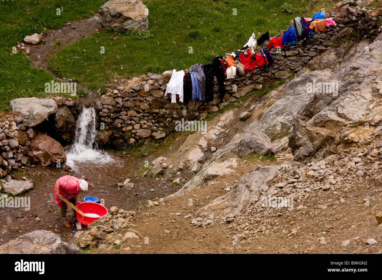Wash day in a snow flurry at Berber village high in the Imlil valley ...