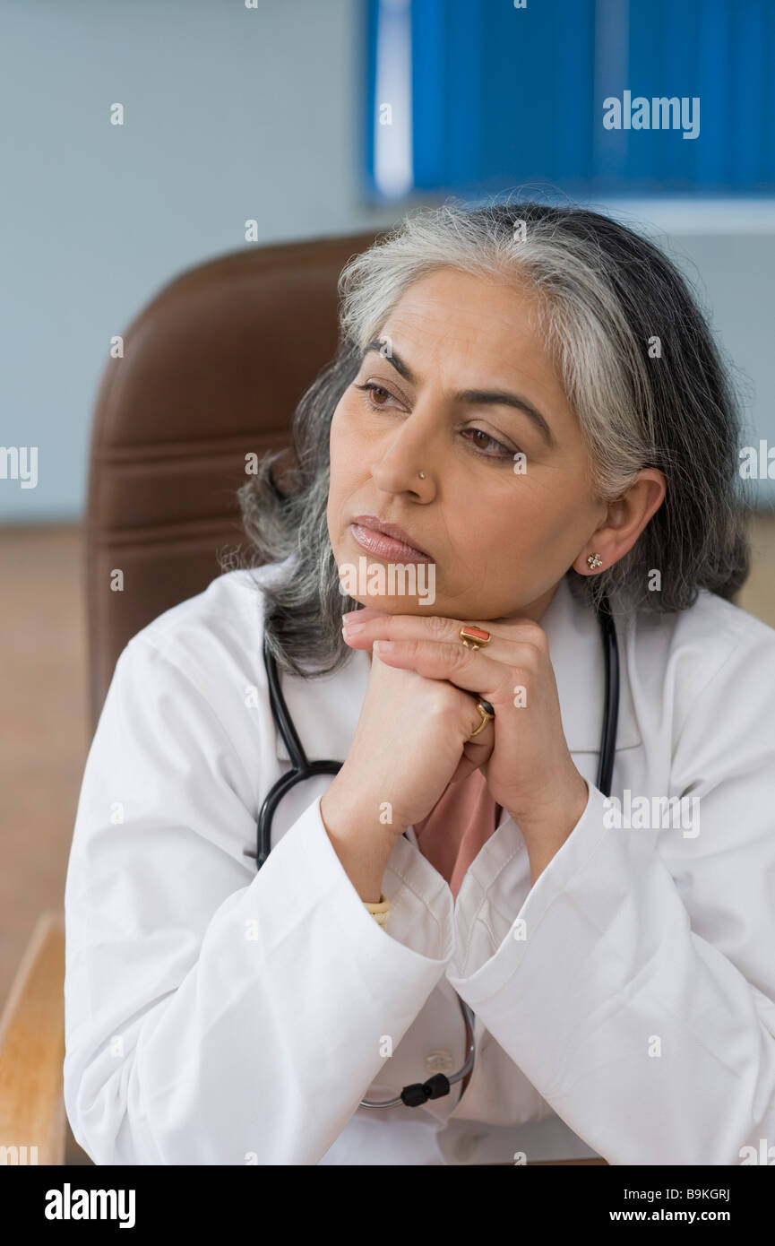 Close-up of a female doctor thinking Stock Photo - Alamy