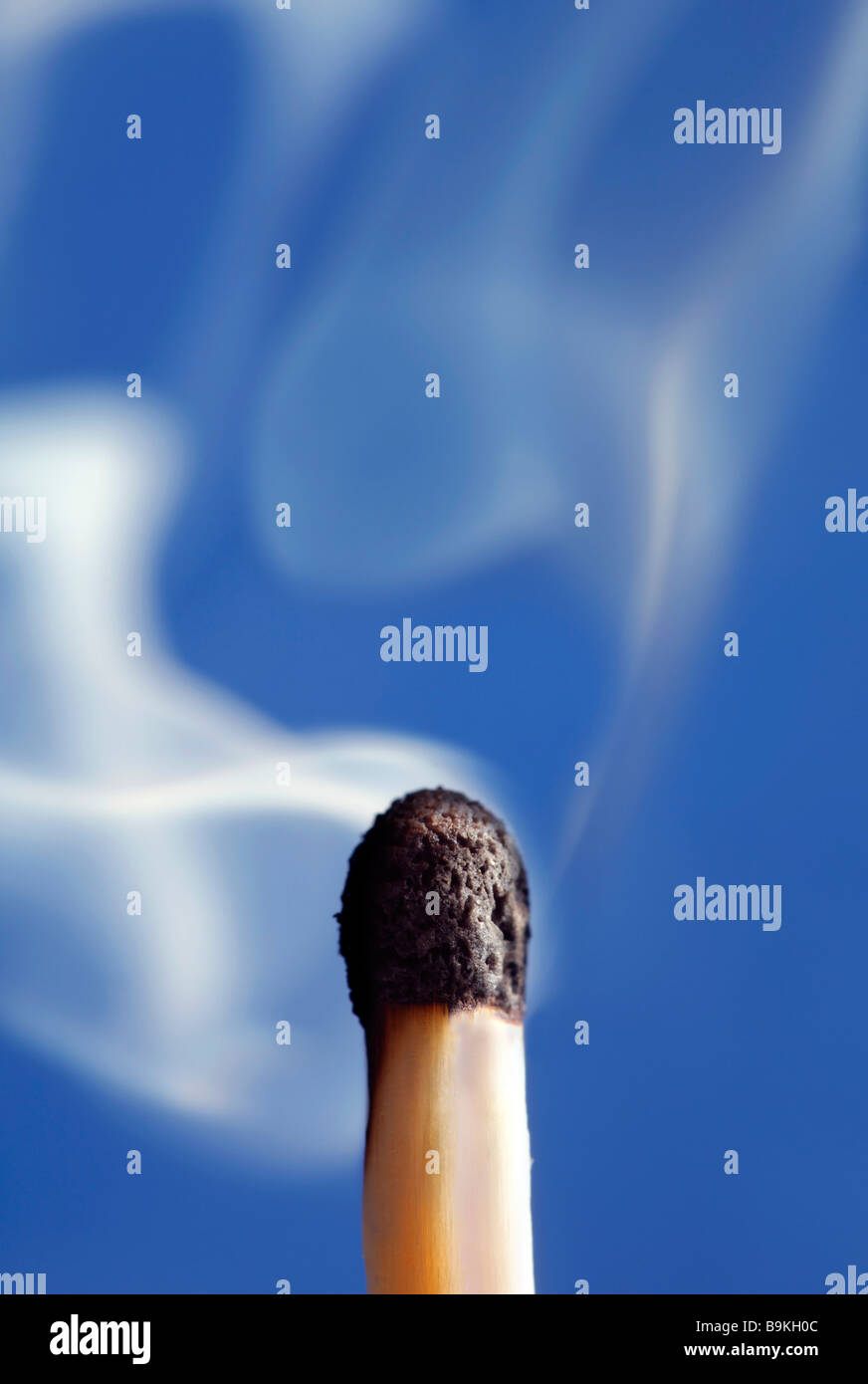 Close up of Smoking match on blue background Stock Photo - Alamy