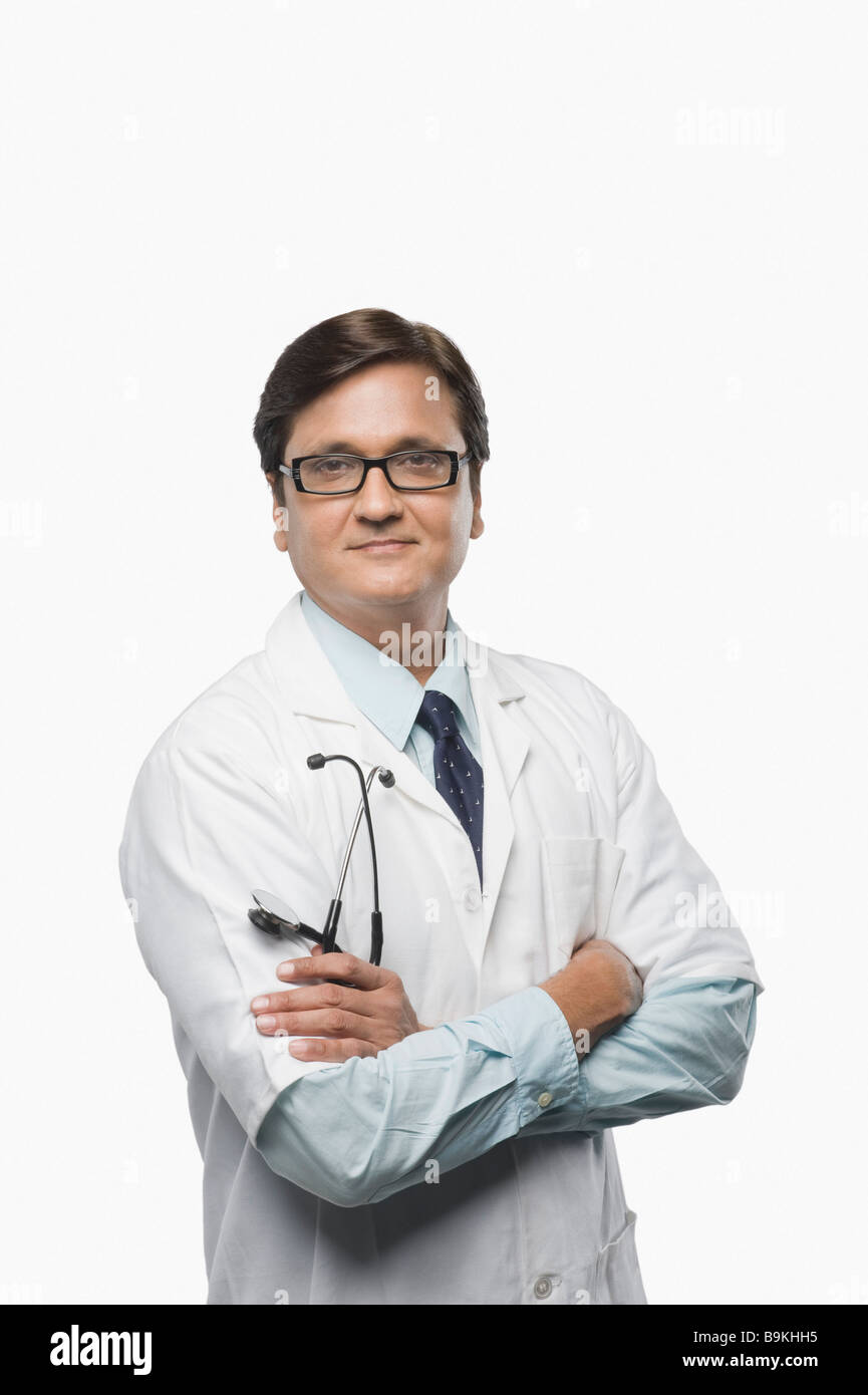 Doctor standing with his arms crossed Stock Photo - Alamy