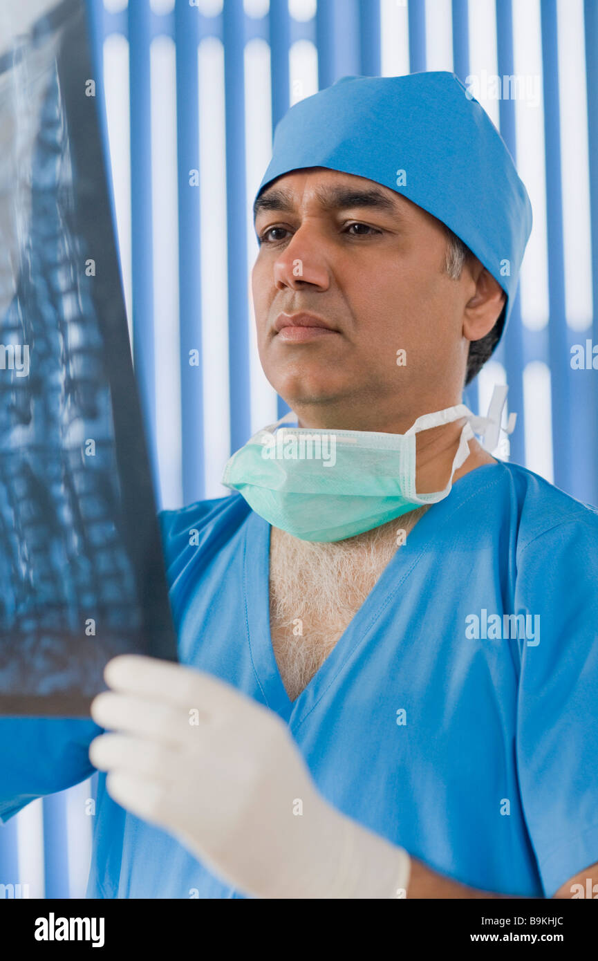 Surgeon examining an x-ray report Stock Photo - Alamy