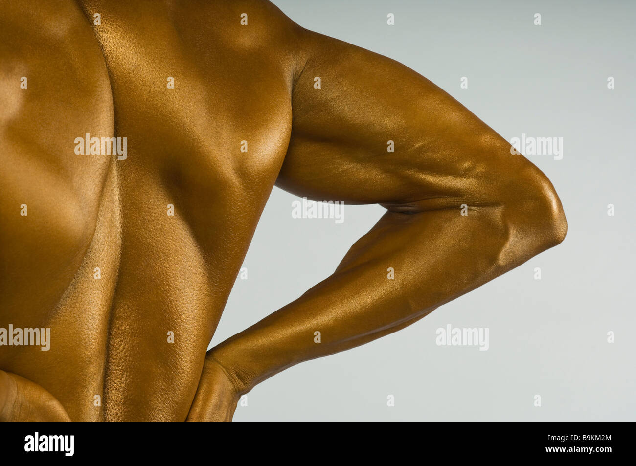 Rear view of a man flexing muscles Stock Photo - Alamy