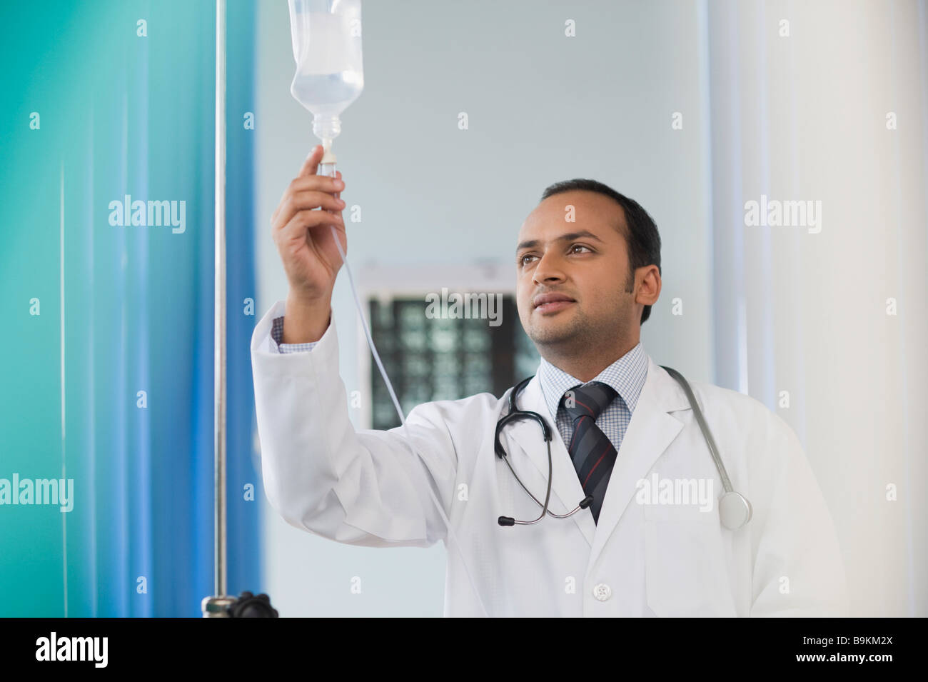 Doctor checking a saline drip Stock Photo - Alamy