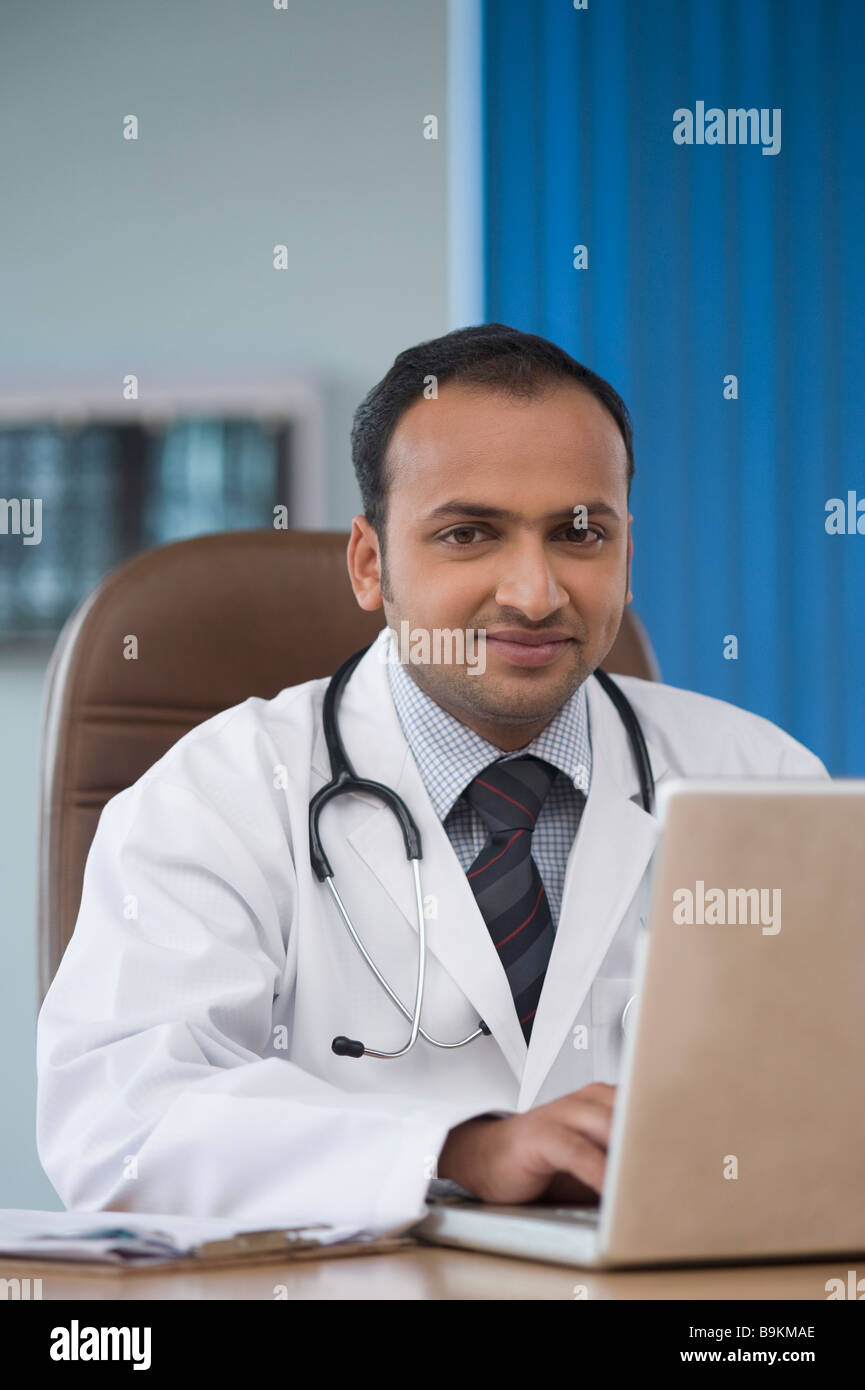 Indian male doctor looking laptop hi-res stock photography and images ...