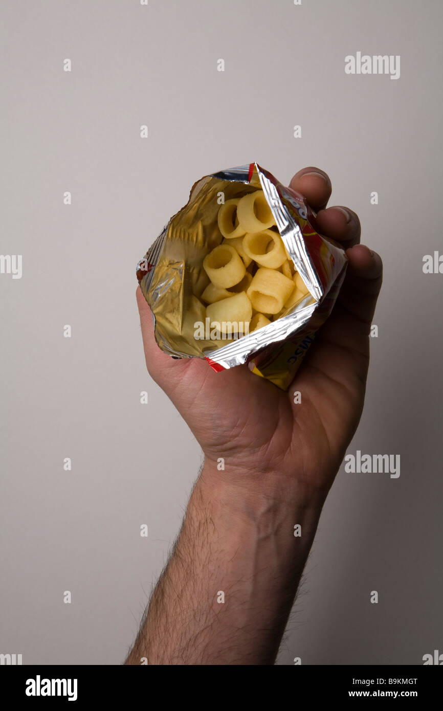 hand holding hula hoop crisps Stock Photo - Alamy
