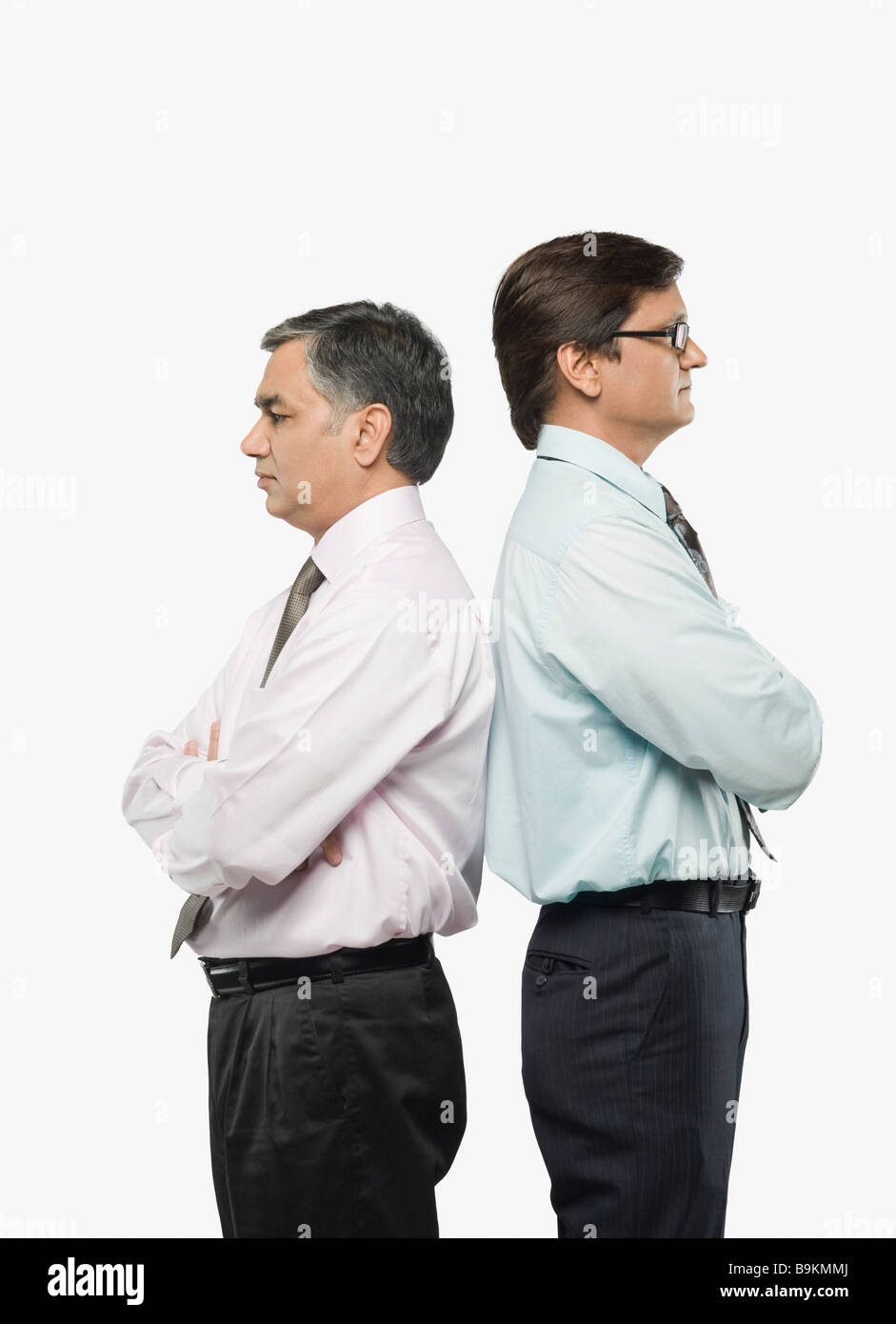 Two businessmen standing back to back Stock Photo - Alamy