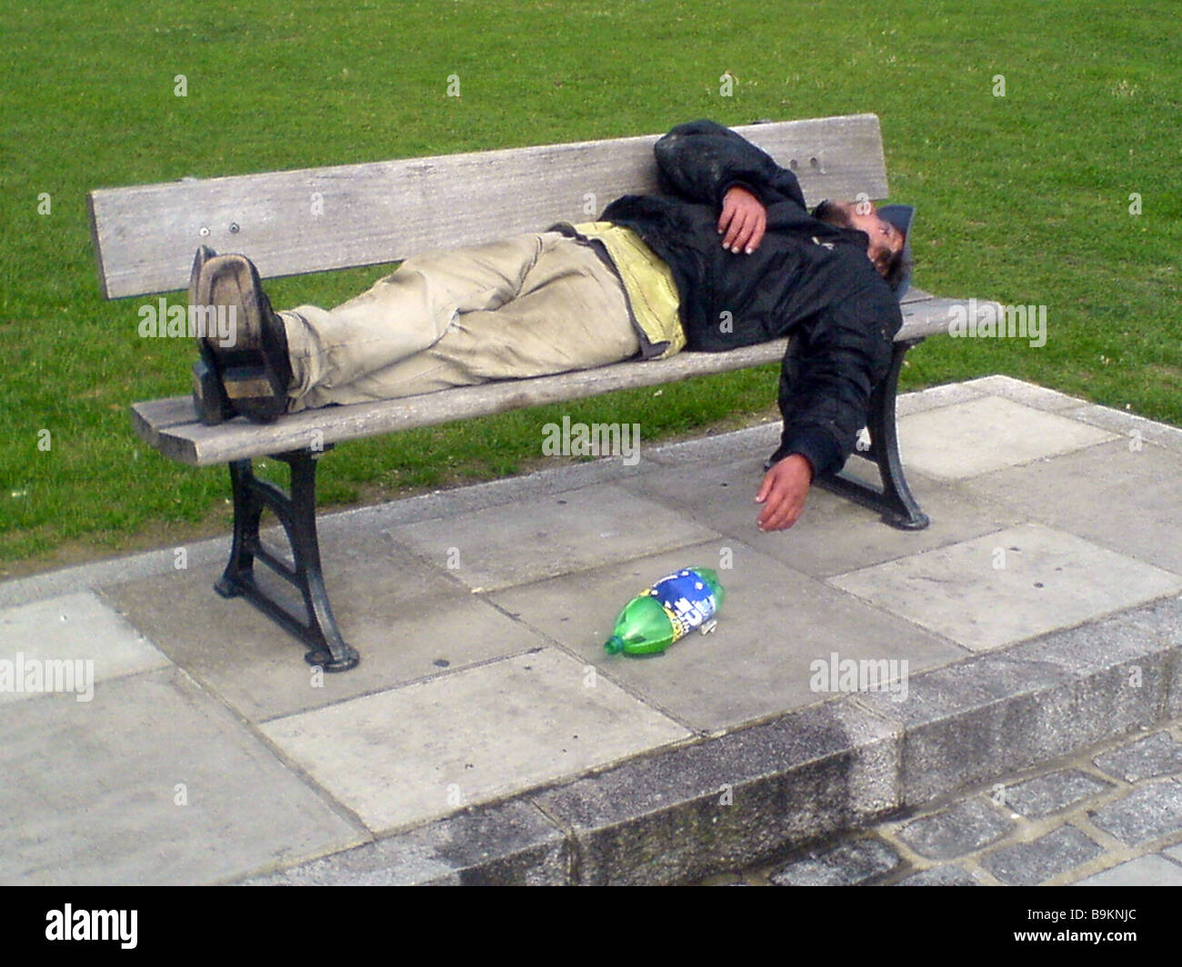 drunk strong cider drinker sleeping on park bench Stock Photo - Alamy