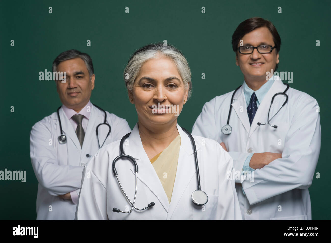 Portrait of three doctors smiling Stock Photo - Alamy