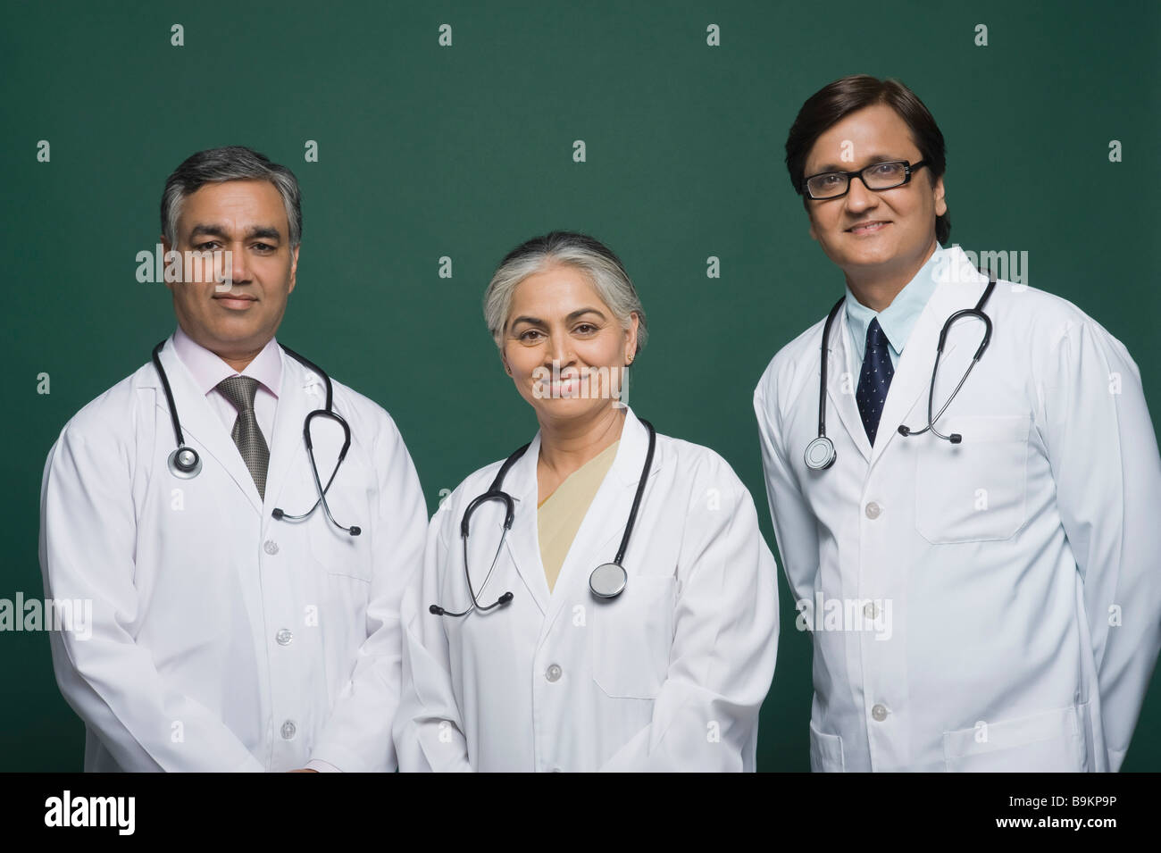 Portrait of three doctors smiling Stock Photo - Alamy