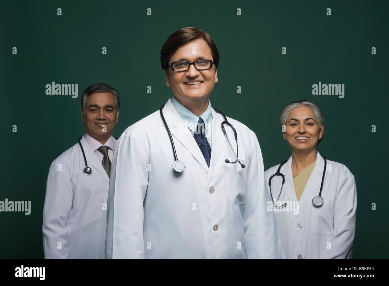 Portrait of three doctors smiling Stock Photo - Alamy