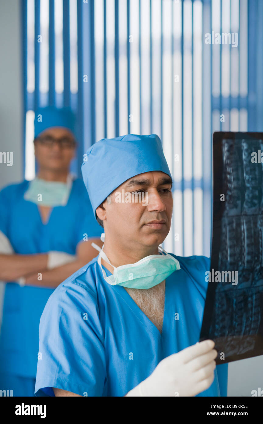 Surgeon examining an x-ray report Stock Photo - Alamy