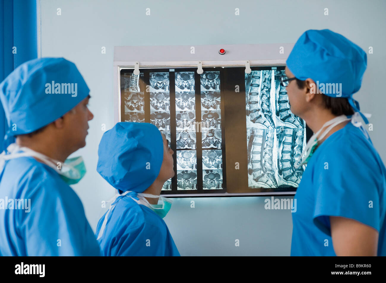 Analyzing surgical team examining hi-res stock photography and images ...