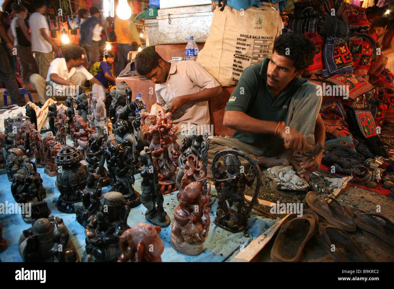 Local men carving crafts at the saturday night market at Baga in Goa ...