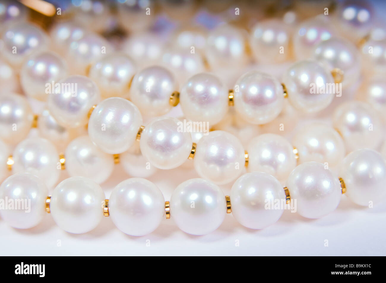 Pearls on a white background Stock Photo - Alamy