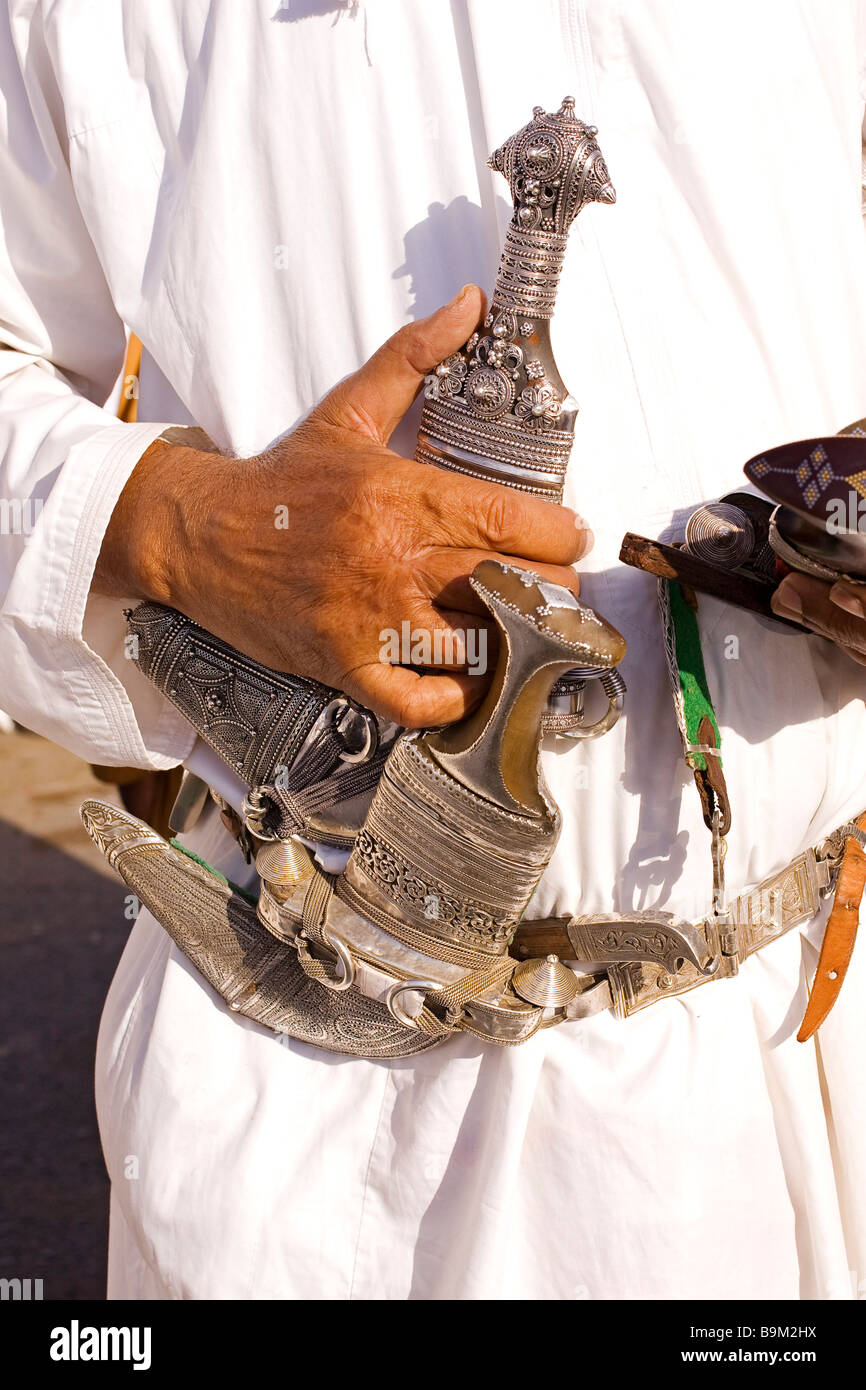 Oman Sultanate, man with khanjar knives (engraved silver curved daggers ...