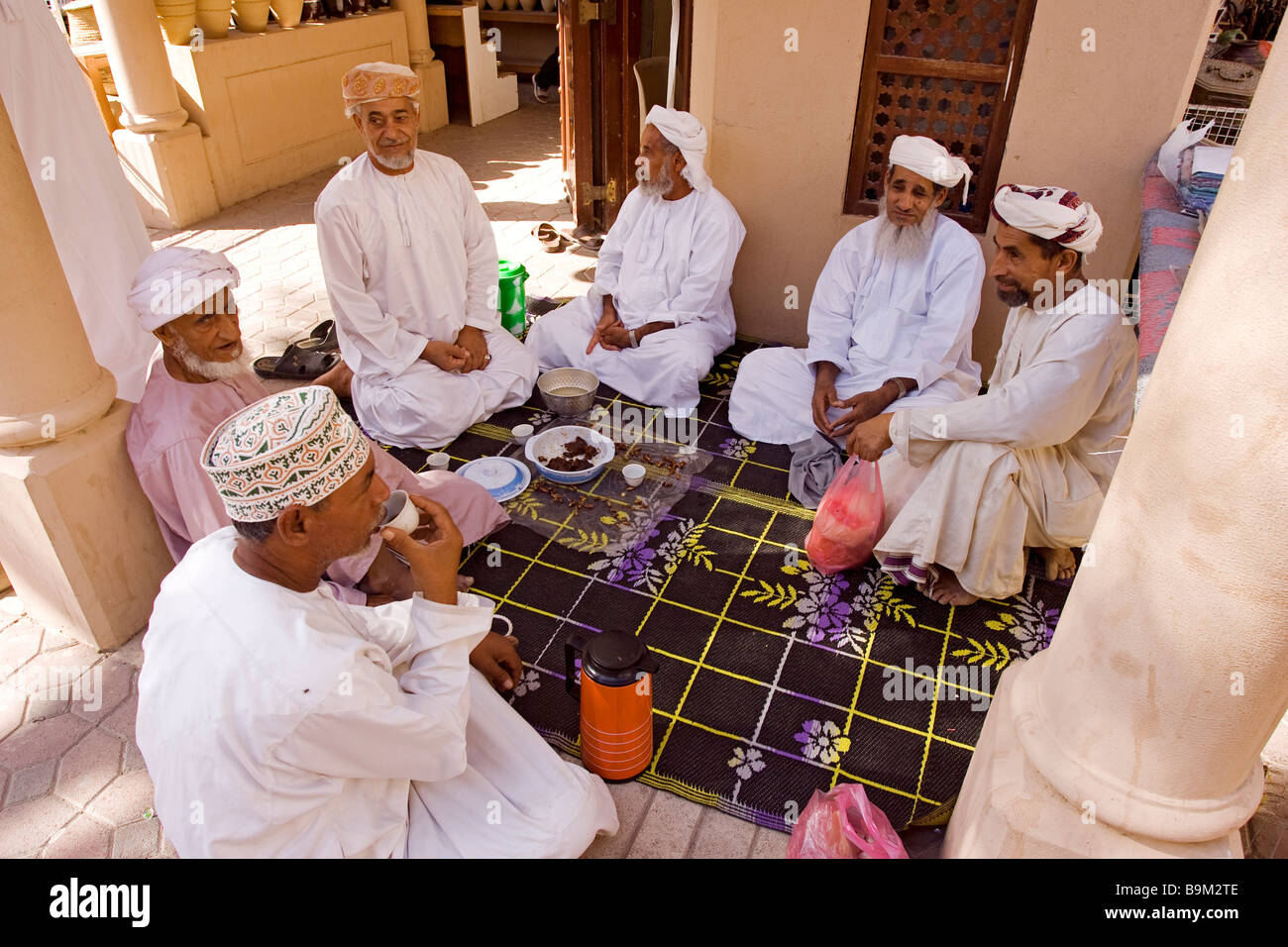 Oman, a group of men drinking tea Stock Photo - Alamy